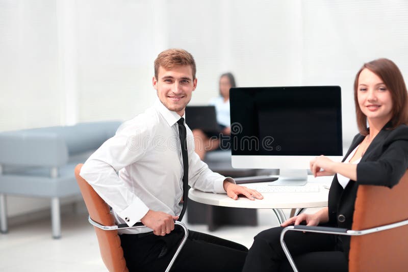 Smiling Member of the Business Team Sitting at Desk Stock Photo - Image ...