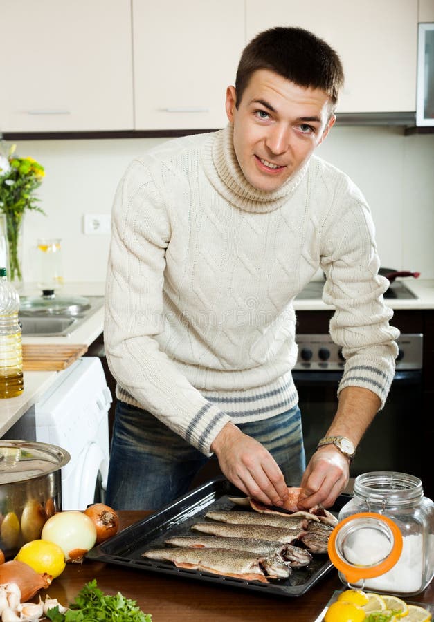 Smiling Men Cooking Trout Fish Stock Photo - Image of frypan, cooking ...