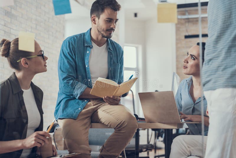 Young Partners are Having Conversation in Office Stock Photo - Image of ...