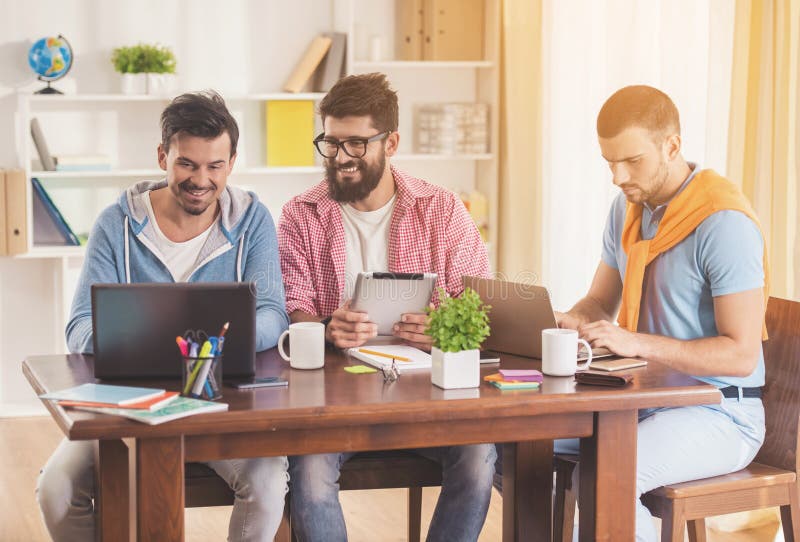Smiling Men Working with Laptops and Tablets. Stock Photo - Image of ...