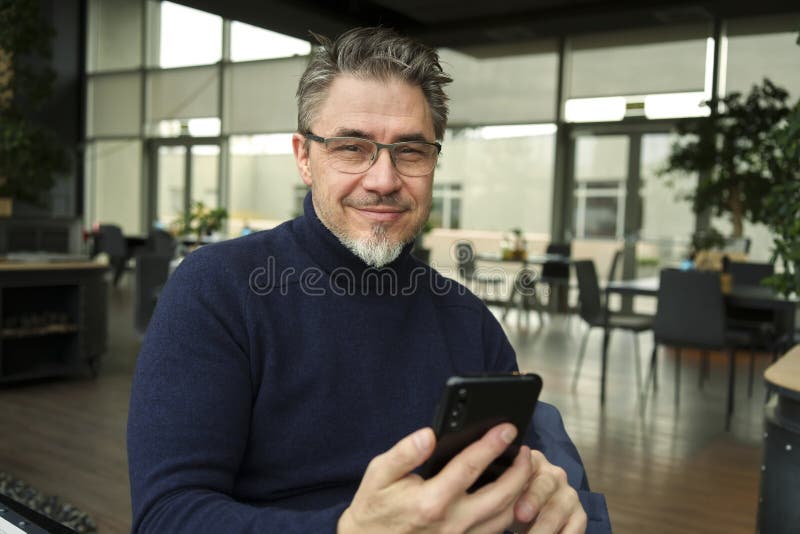 Middle Age Man Using Phone in Restaurant or Cafe Stock Image - Image of ...