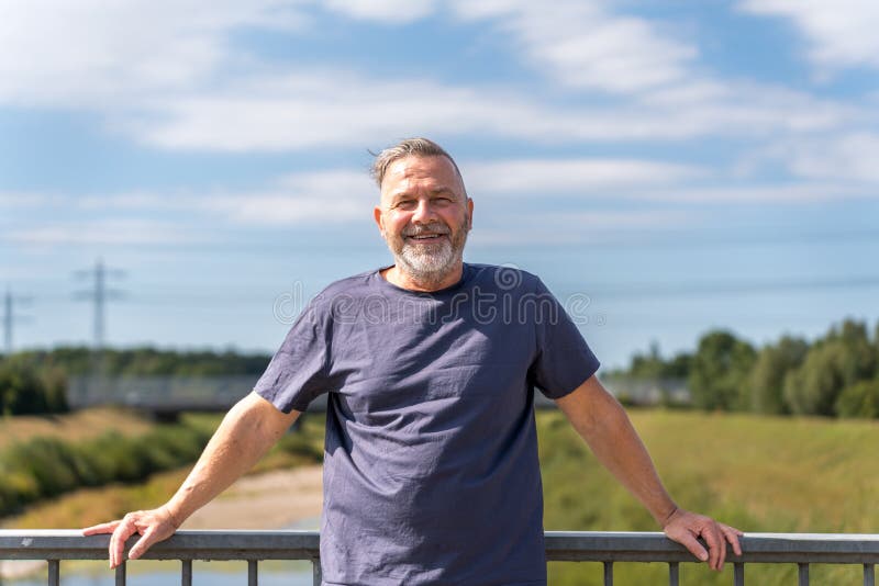 Smiling Middle Aged Man on a Bridge Stock Photo - Image of middle ...