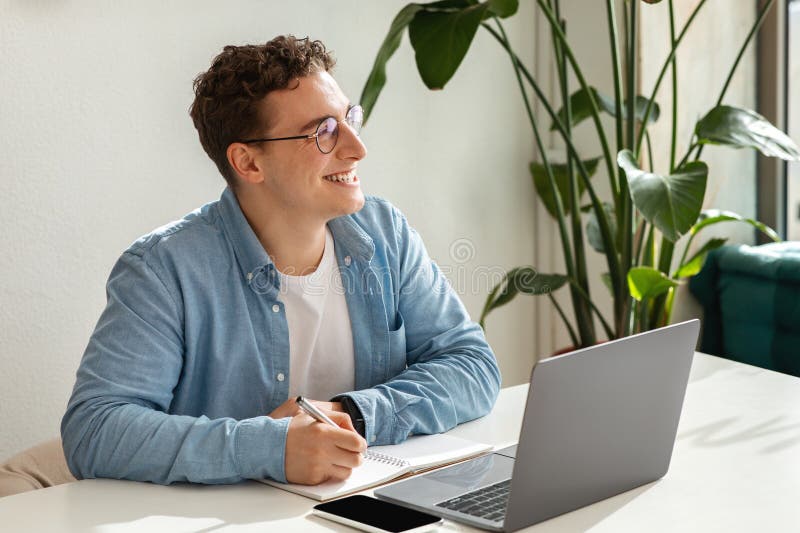 Smiling Millennial Caucasian Guy Student in Glasses, Typing on Computer ...