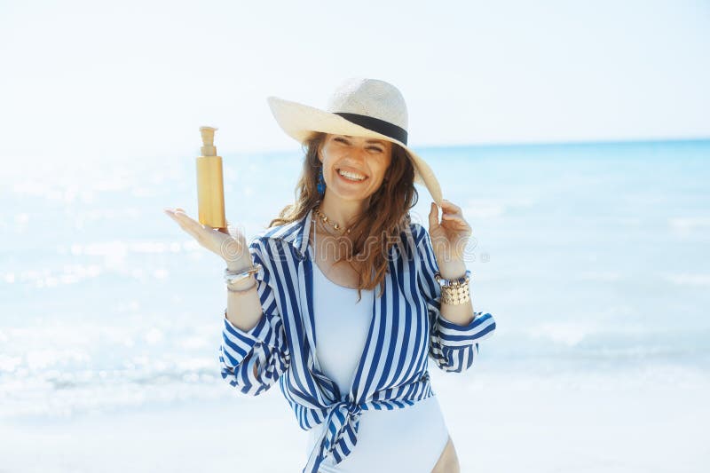 Smiling Modern Woman on Ocean Shore with Spf Stock Photo - Image of ...