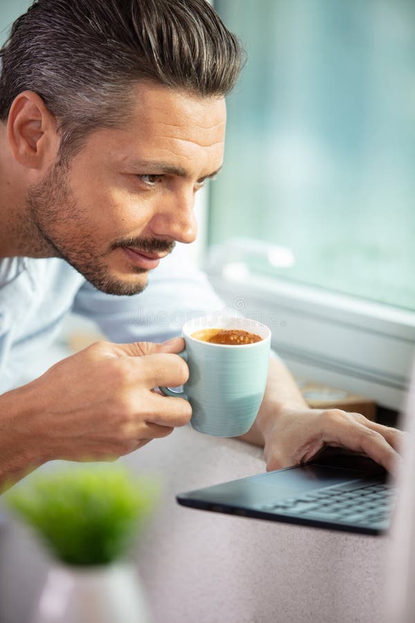Smiling Modern Young Man Using Gadgets at Cafe Stock Photo - Image of ...