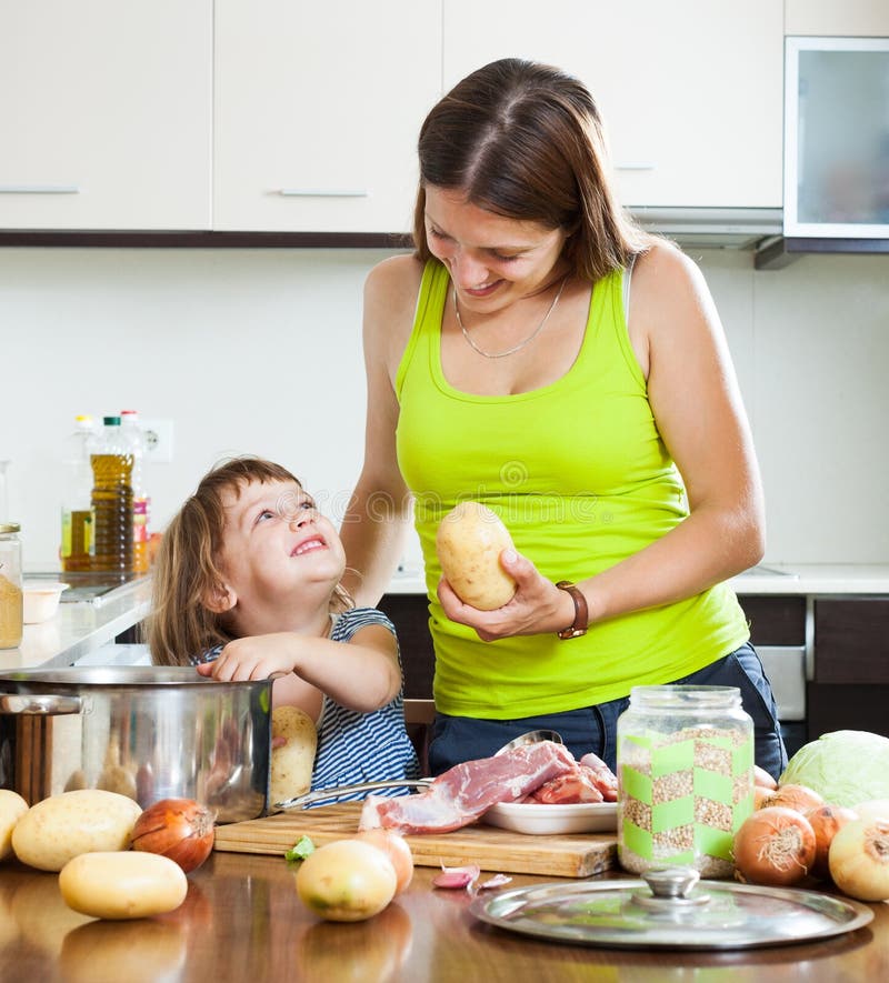 Smiling Mother with Child Cooking Stock Photo - Image of kitchen ...