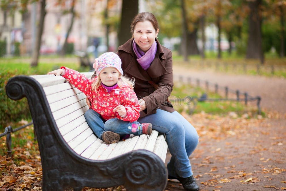 Smiling Mother and Daughter on a Bench Stock Photo - Image of childhood ...