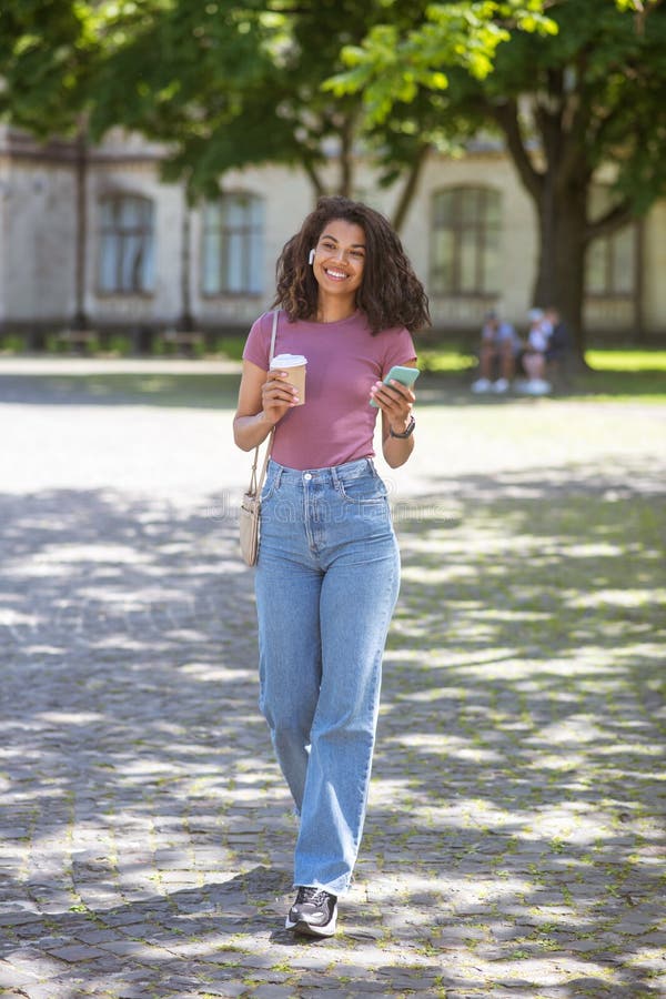 Smiling Mulatta with a Coffee Cup in Hands in the Park Stock Image ...