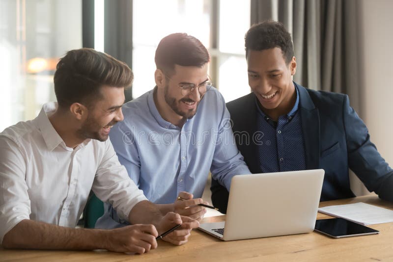 Diverse Colleagues Working Together Using Laptop Feeling Satisfied and ...