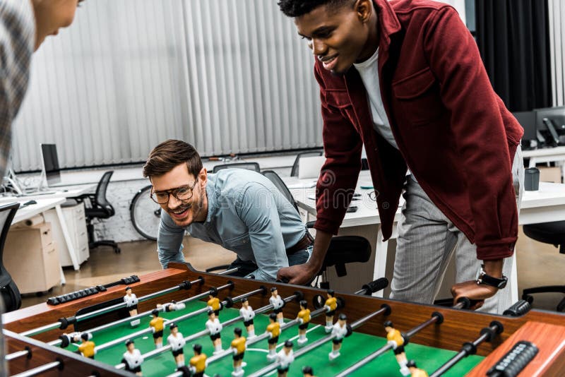 Smiling Multicultural Businessmen Playing Table Football Stock Photo ...