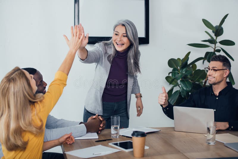 Multicultural Colleagues Giving High Five and Stock Photo - Image of ...