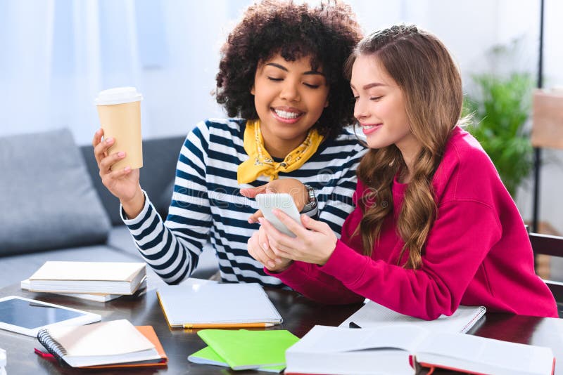 Smiling Multicultural Students Using Smartphone while Stock Image ...