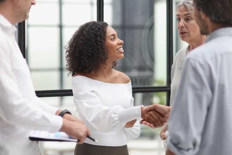 Smiling Multiethnic Businesspeople Shaking Hand in Office Stock Photo ...