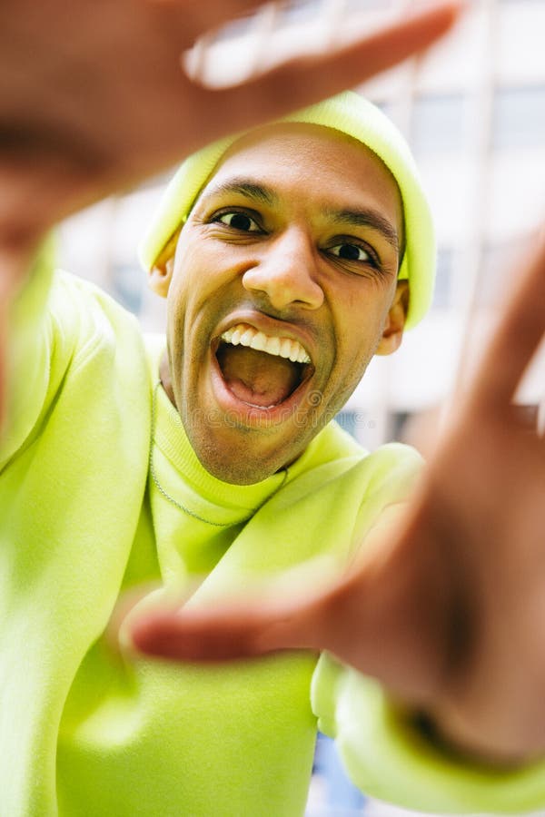 Smiling Multiracial Man Framing the Camera with Hands in City Stock ...
