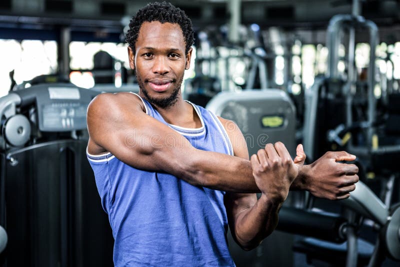 Smiling Muscular Man Stretching Arms Stock Photo - Image of ...