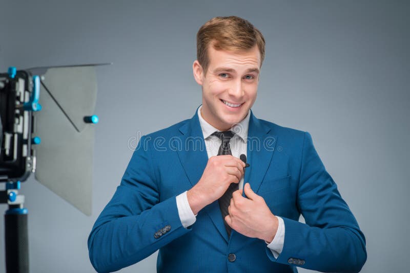 Smiling Newsman Adjusting the Microphone Stock Image - Image of newsman ...