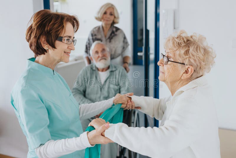 Nurse Holds an Elderly Lady`s Hands, Helping Her Stock Image - Image of ...
