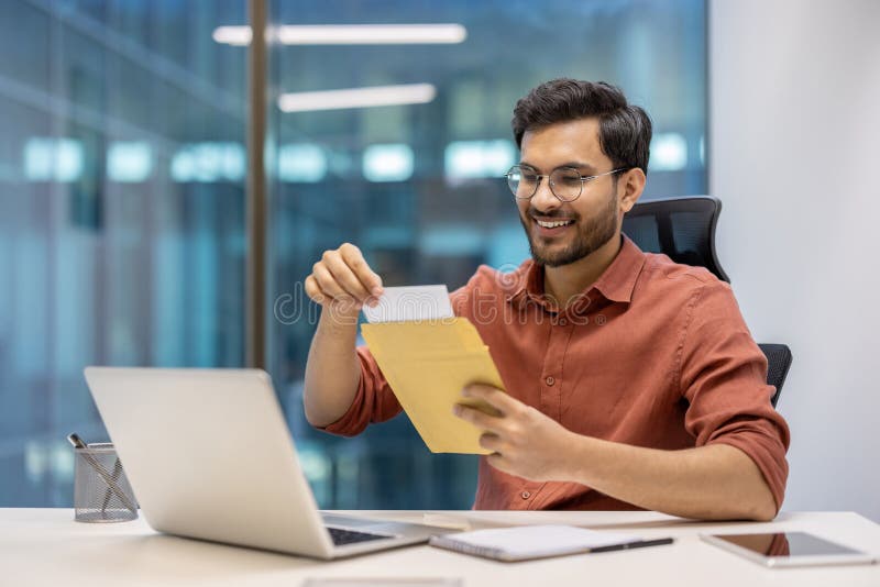 Smiling Office Worker Opening Envelope while Working at Desk with ...