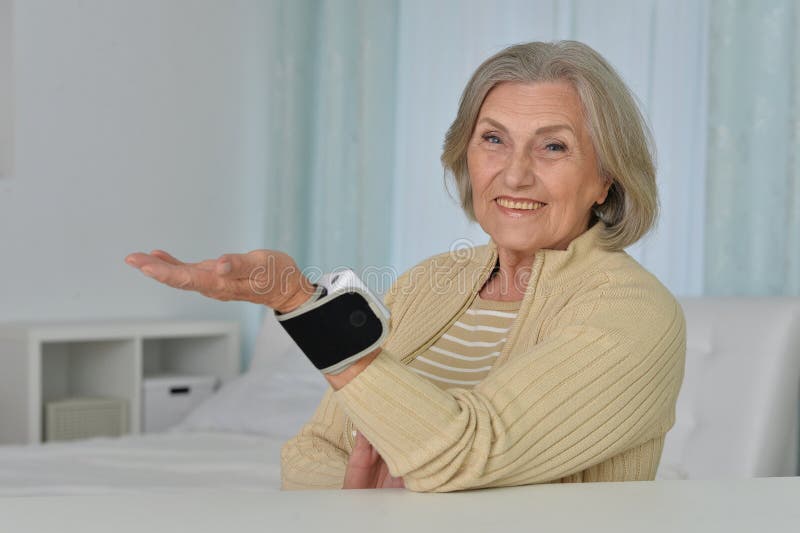 Smiling Old Woman Using Automatic Carpal Tonometer in Hospital Stock ...