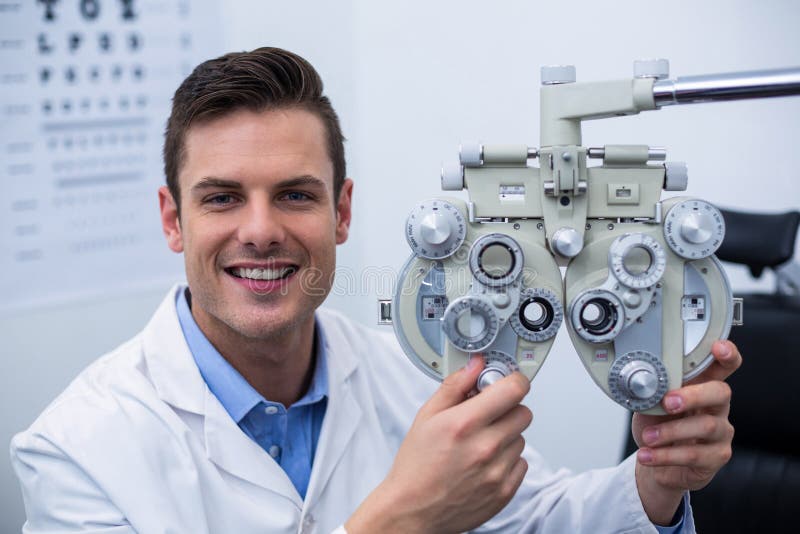 Smiling Optometrist Adjusting Phoropter Stock Photo - Image of ...