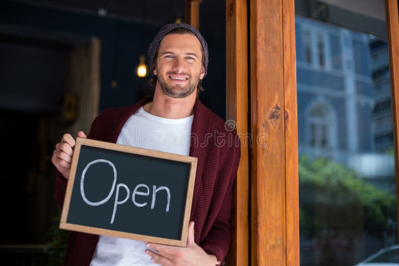 Smiling Owner Leaning with Open Sign Board in Cafe Stock Image - Image ...