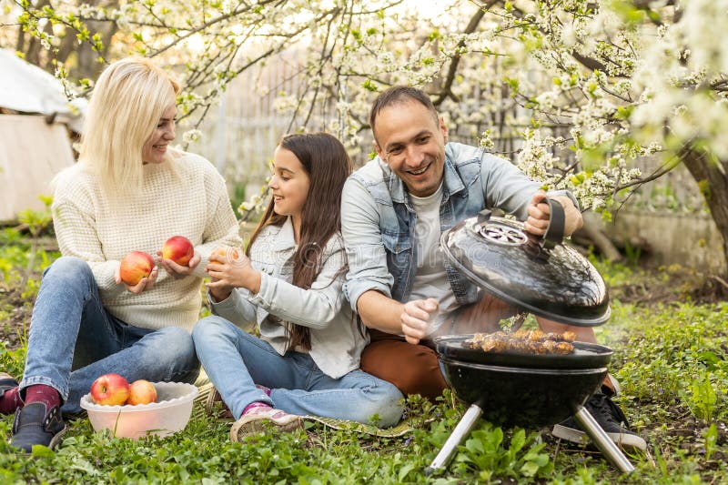 Smiling Parent Grilling Meat with Daughter on Camping Stock Image ...