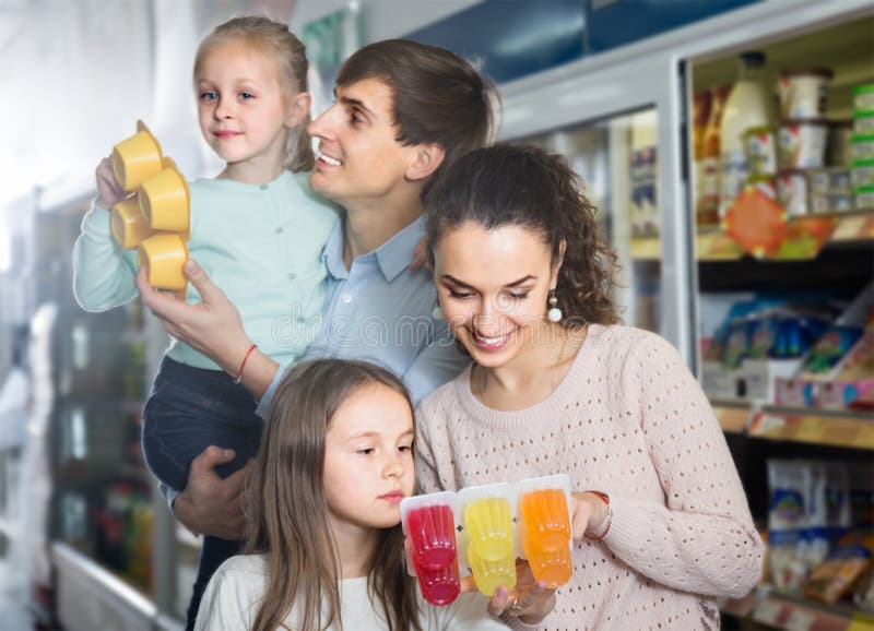 Smiling Parents with Two Kids Holding Purchases in Store Stock Image ...