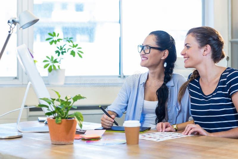 Smiling Partners Working Together on Computer and Digitizer Stock Image ...