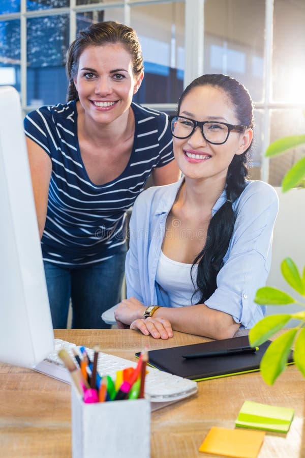 Smiling Partners Working Together on Computer Stock Photo - Image of ...