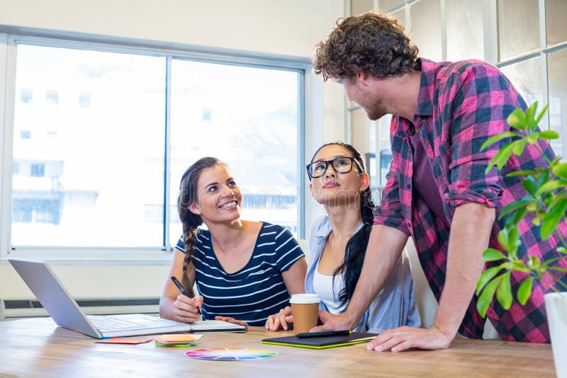 Smiling Partners Working Together on Laptop and Digitizer Stock Photo ...