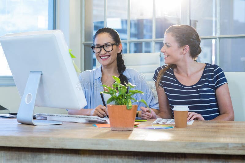 Smiling Partners Working Together with Photographs and Digitizer Stock ...