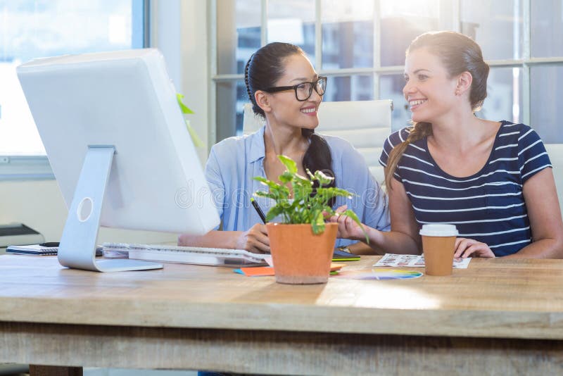 Smiling Partners Working Together with Photographs and Digitizer Stock ...