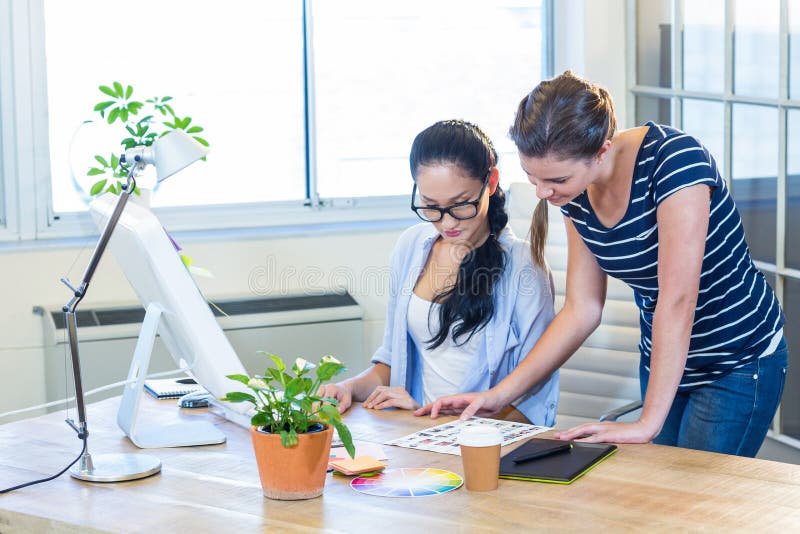 Smiling Partners Working Together with Photographs Stock Photo - Image ...