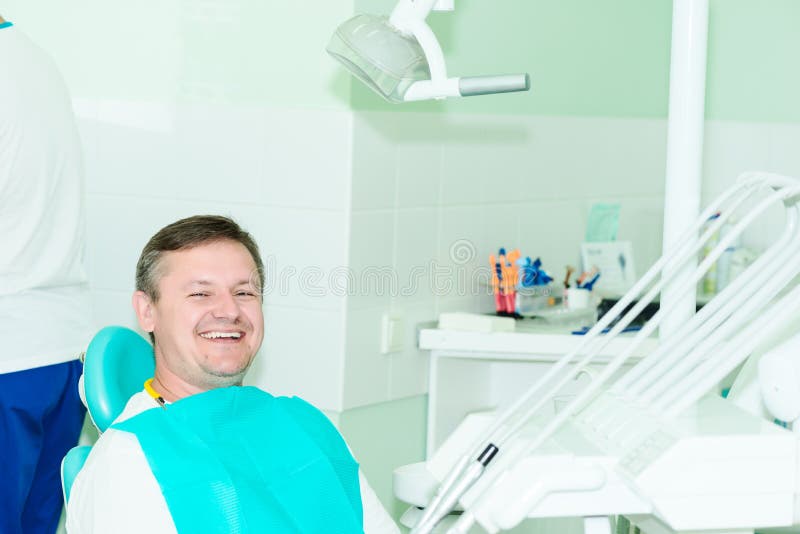 Smiling Patient Looking at Camera at the Dentist Office Stock Photo ...