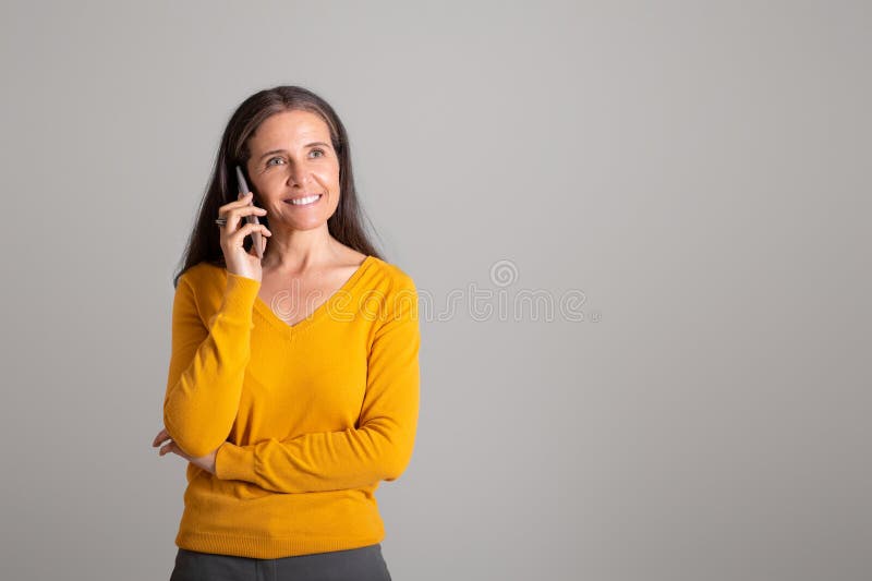 Smiling Pensive Caucasian Aged Lady Calling by Phone, Looking at Empty ...