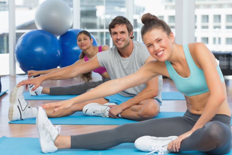 Smiling People Doing Stretching Exercises Stock Image - Image of ...