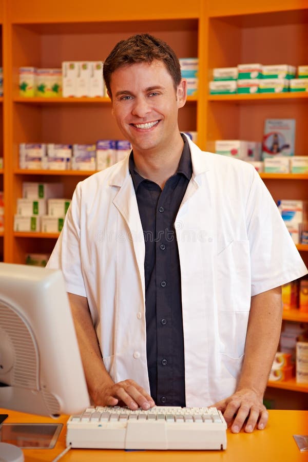 Smiling Pharmacist Behind Counter Stock Image - Image of medicines ...