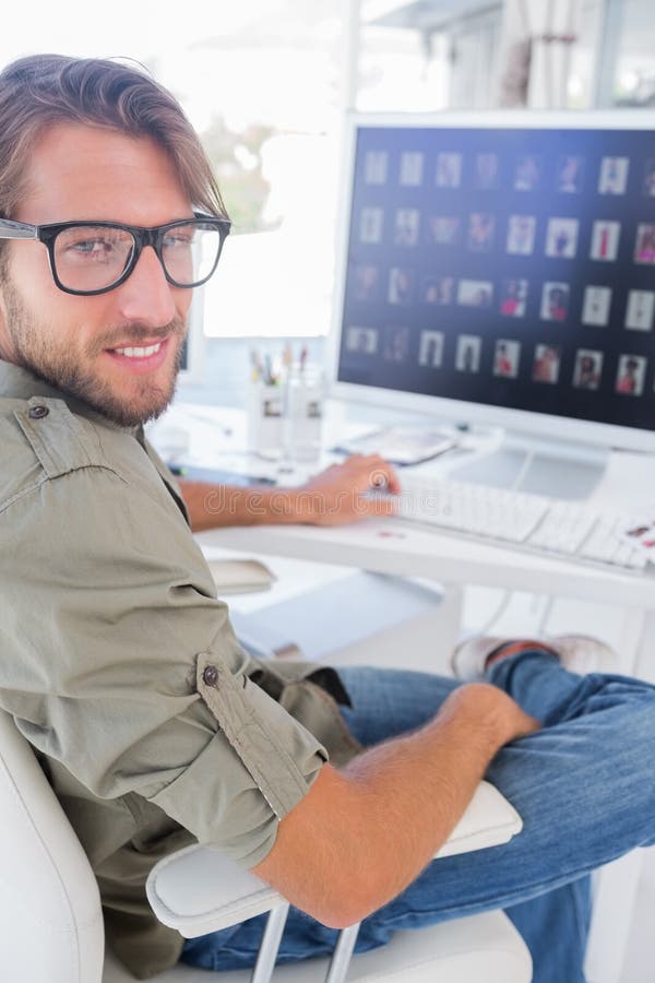 Smiling Photo Editor at His Desk Stock Image - Image of career, editor ...