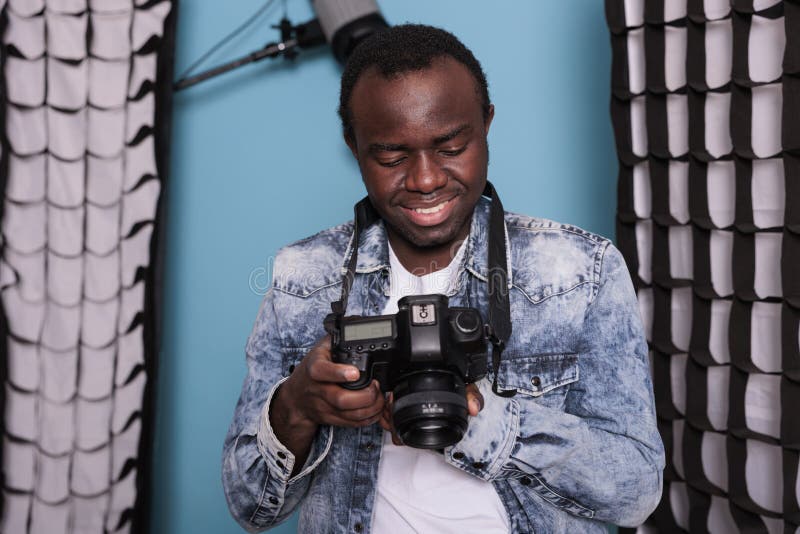 Smiling Photographer Checking Camera Gallery while Standing in ...