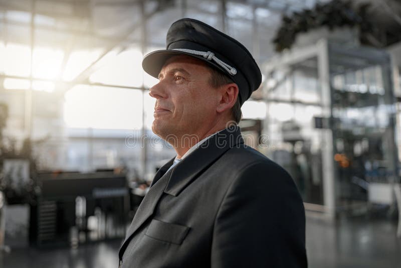 Smiling Pilot Standing and Looking at Airport Terminal Stock Photo ...