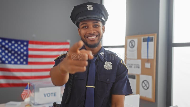 A Smiling Policeman Pointing at the Camera in a Voting Center with an ...