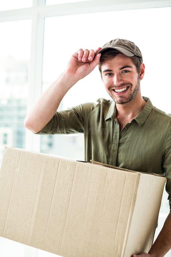 Smiling Postman Holding Package Stock Image - Image of cardboard ...