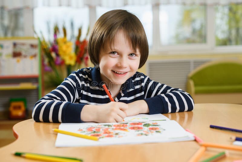 Smiling Preschool Boy Draws in His Notebook Stock Photo - Image of ...