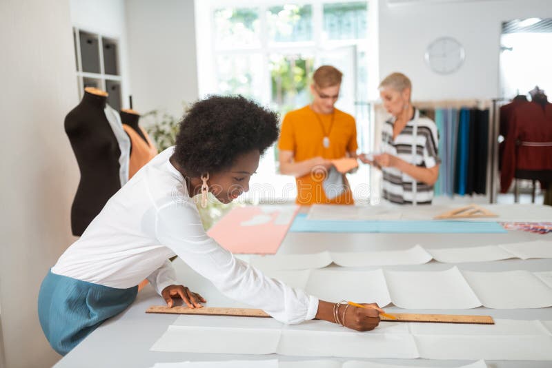 Smiling Pretty Female Tailor Drawing a Paper Pattern Stock Image ...
