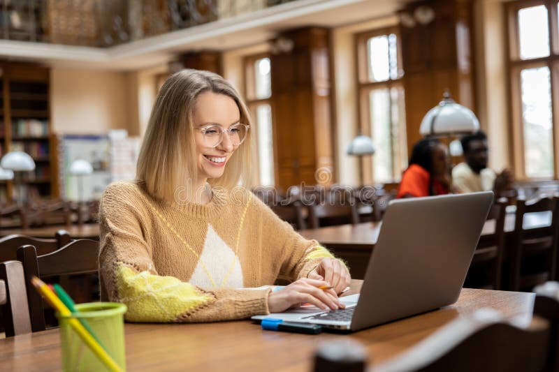 Smiling Pretty Woman Working in the Library Stock Image - Image of ...