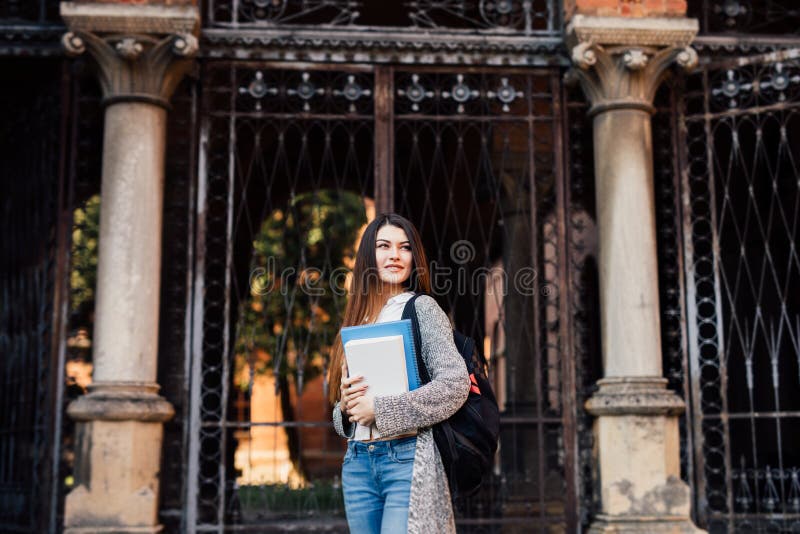 Smiling Pretty Young Woman Student with Backpack Walking Outdoors Near ...