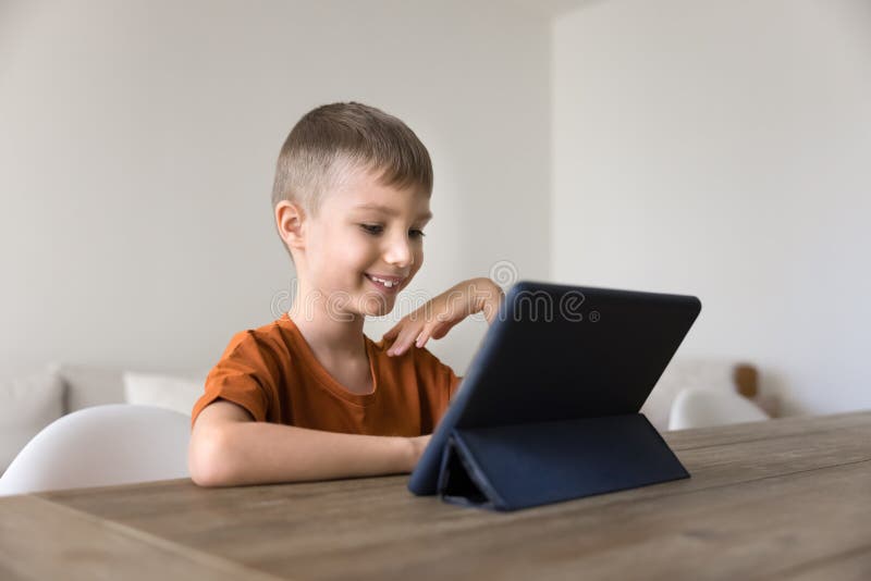 Smiling Primary School Age Boy Studying Using Digital Tablet Stock ...