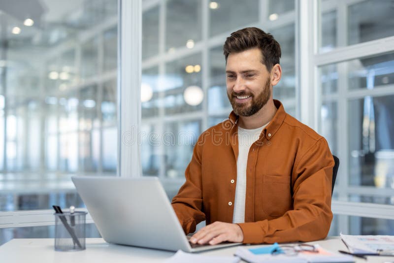 Smiling Professional Man in Modern Office Using Laptop Computer for ...