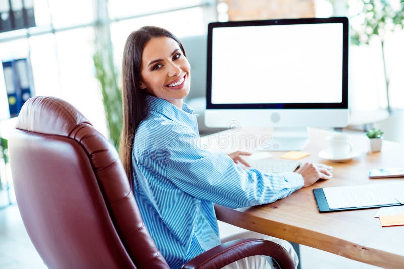 Smiling Professional Woman Working at Modern Office Desk in a Bright ...