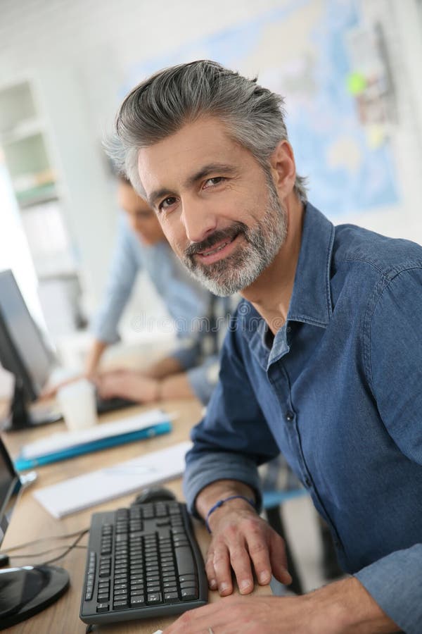Smiling Professor Working on Computer Stock Image - Image of student ...